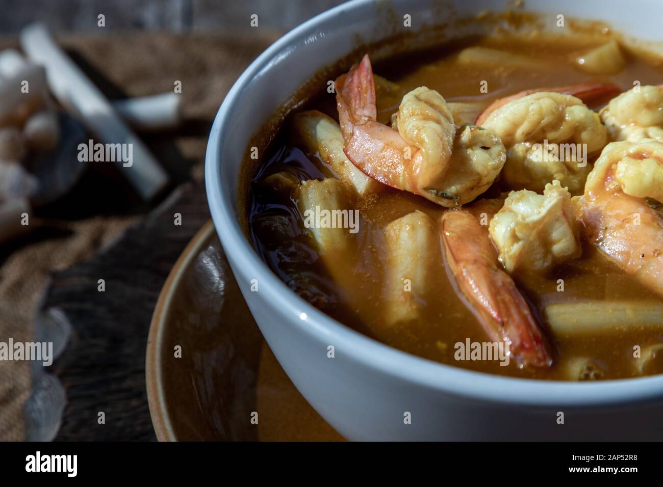 Close-up of Sour soup with lotus stem and shrimps (kaeng som koong with ...