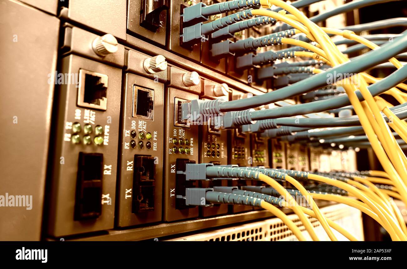 Fiber Optic cables connected to an optic ports and Network cables ...