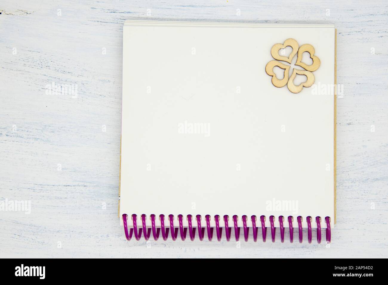 Notepad for notes and wooden hearts in the shape of a happy clover ...