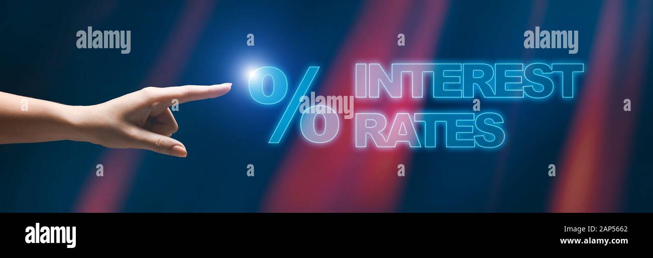 Female hand pointing at neon percentage mark and interest rate ...