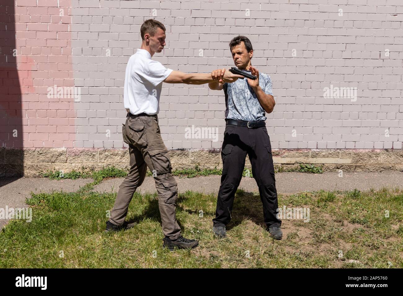 Defender defends itself from the attacker with a gun. Self Defense ...