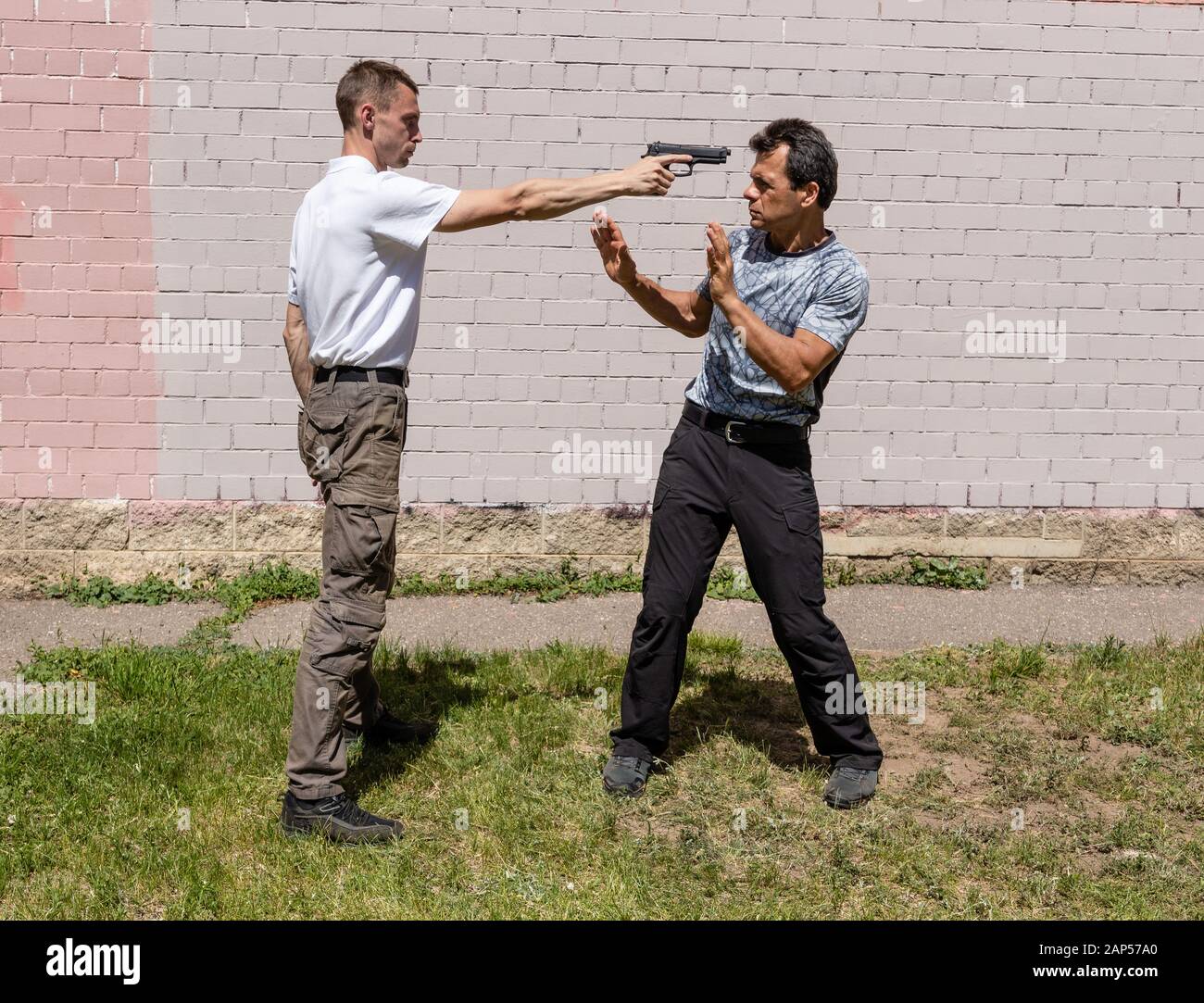 Defender defends itself from the attacker with a gun. Self Defense ...