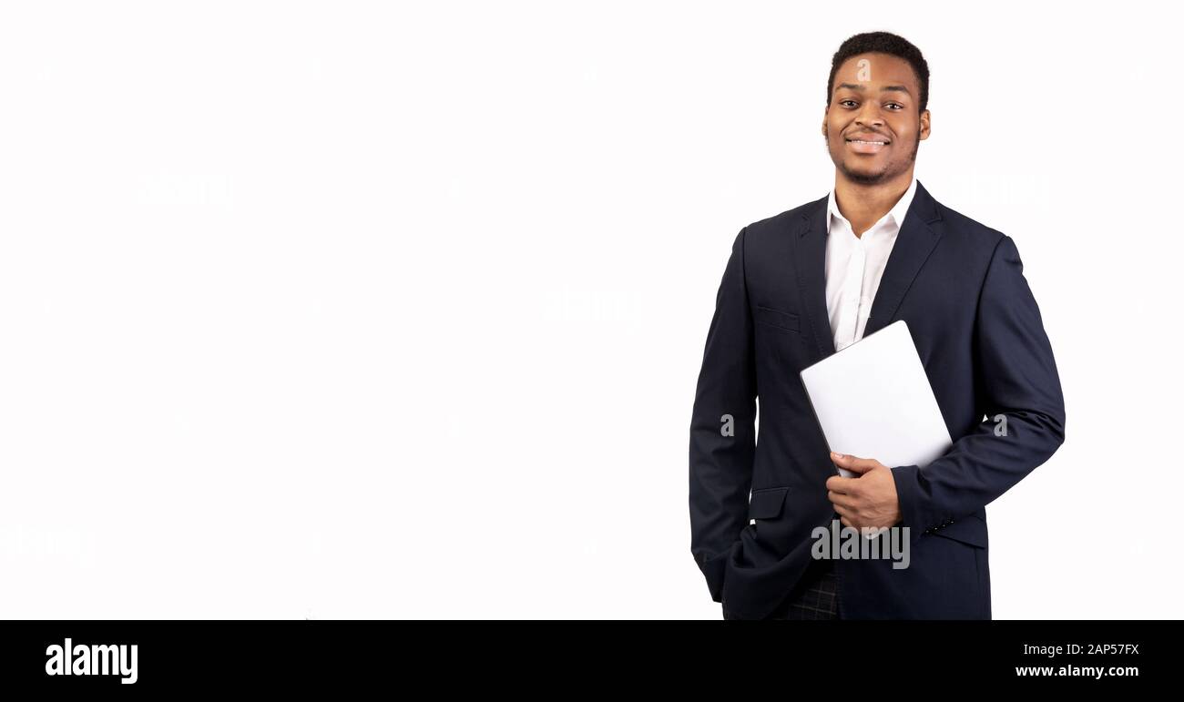 Handsome afro guy holding laptop on white background Stock Photo - Alamy
