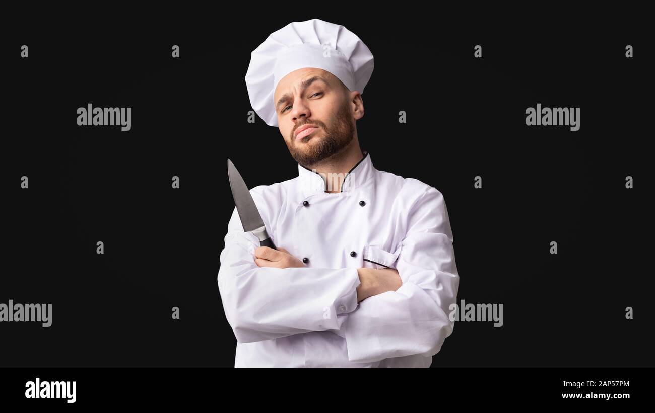 Cook Man Holding Knife Posing In Studio, Panorama Stock Photo - Alamy