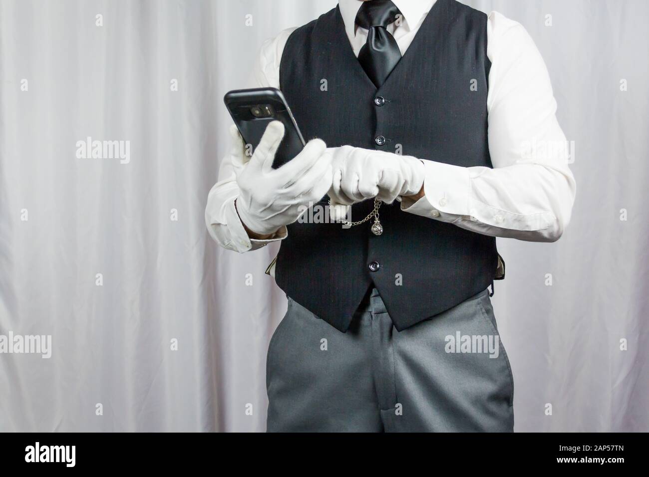 Butler or Waiter in White Gloves Using Mobile Phone. Concept of Service ...