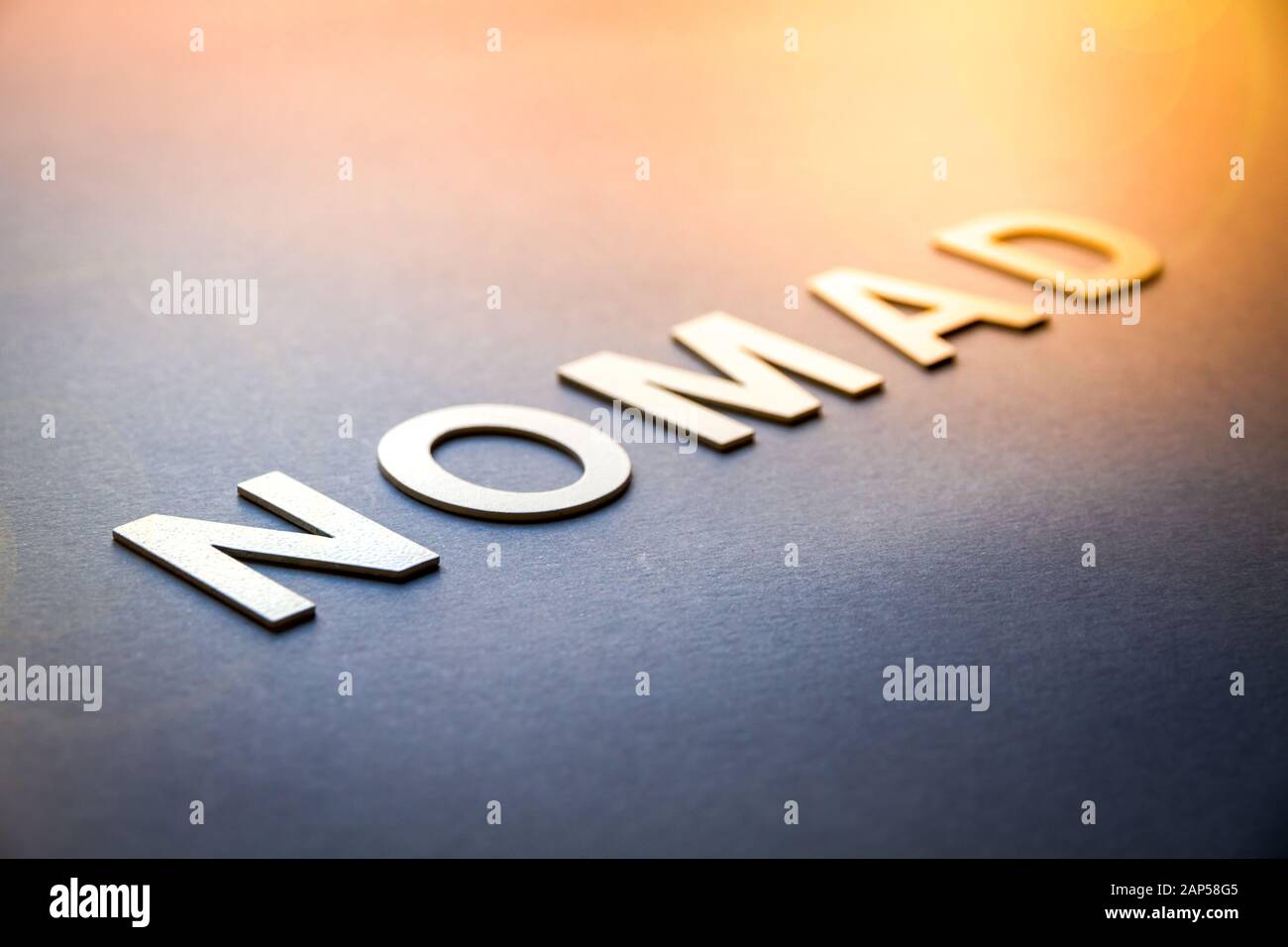 Word nomad written with white solid letters on a board Stock Photo - Alamy