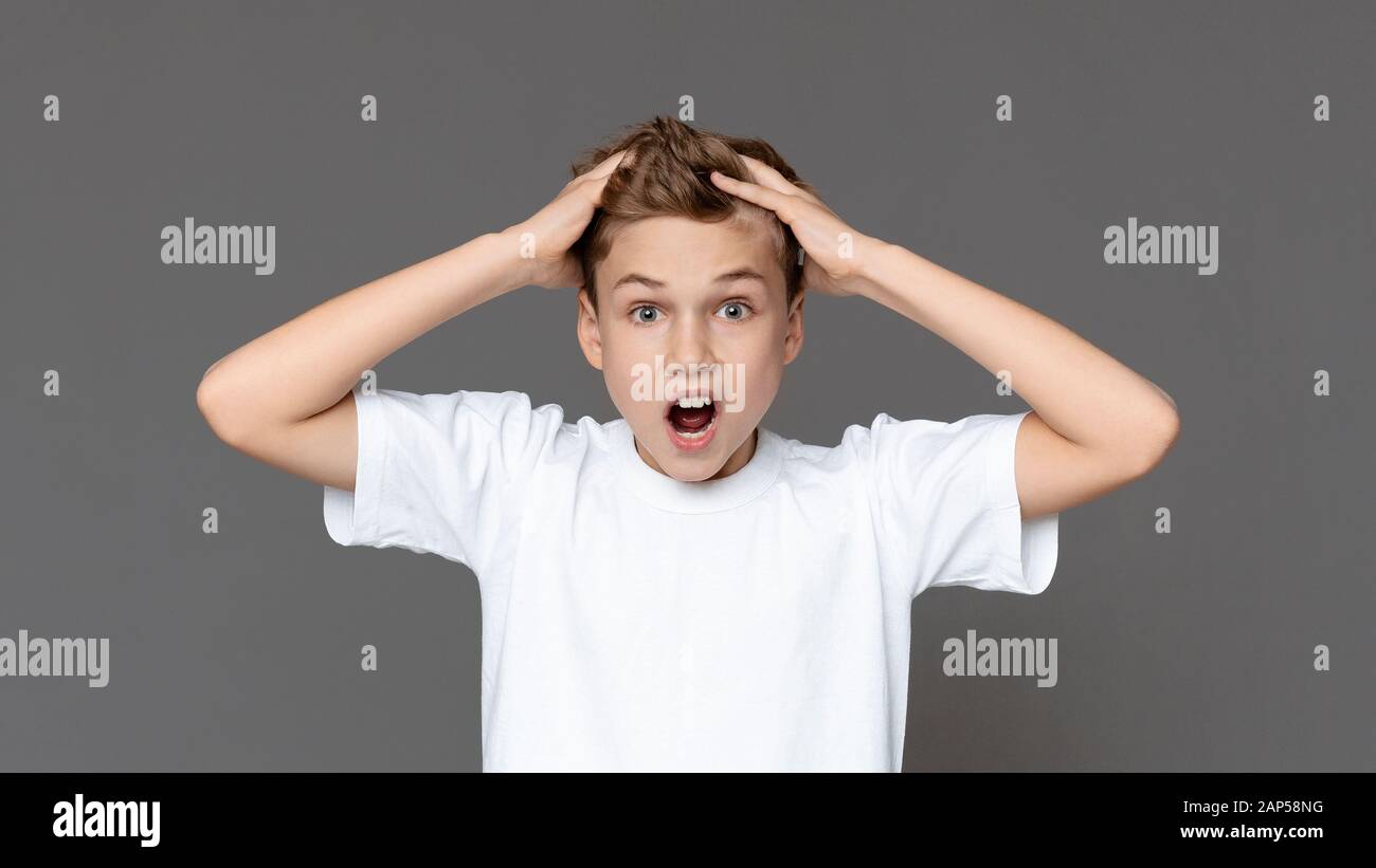 Emotional teen boy screaming and grabbing hair in panic Stock Photo - Alamy