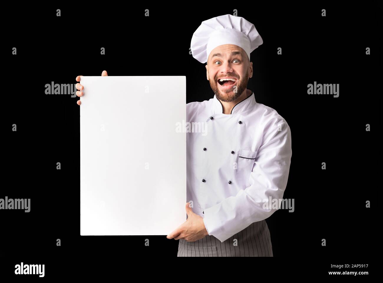 Excited Chef Holding Blank Poster Standing On Black Background, Mockup ...