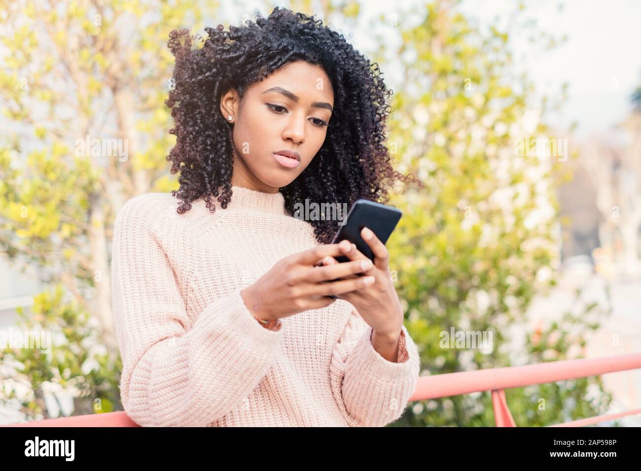 Black afro-american woman using mobile phone Stock Photo - Alamy