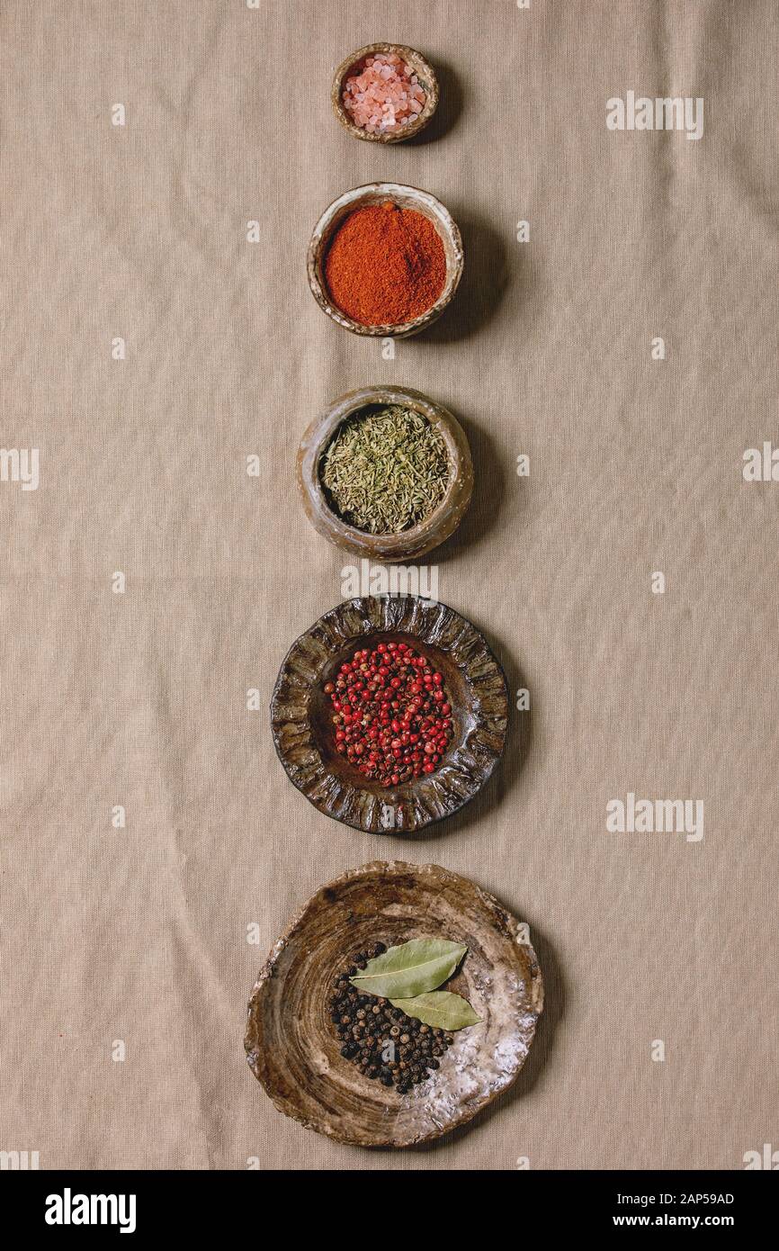 Variety of different handmade ceramic plates and bowls in row with ...