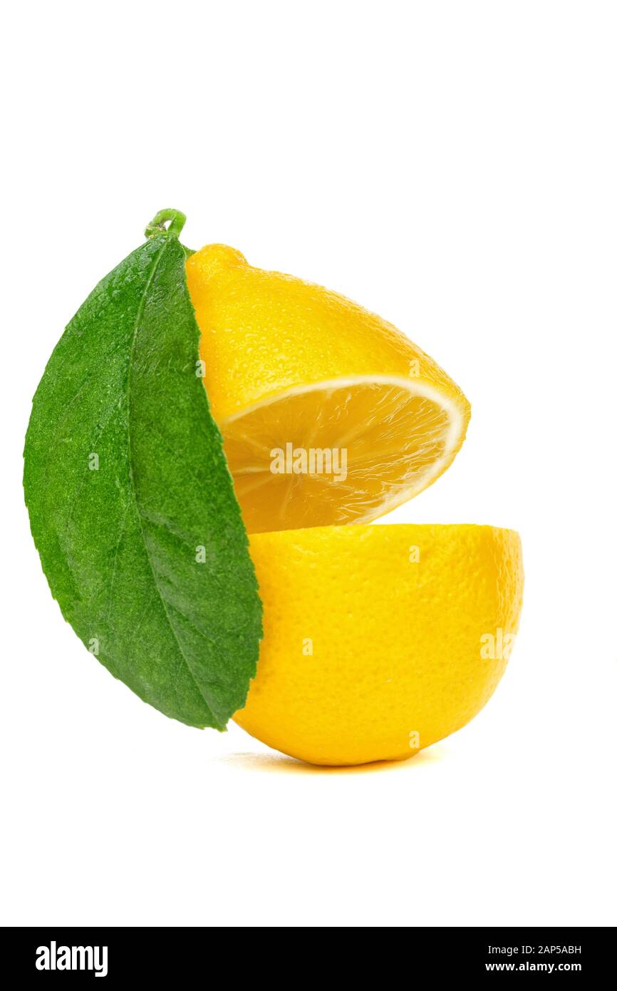 yellow lemon cut into two parts with a leaf isolated on a white ...