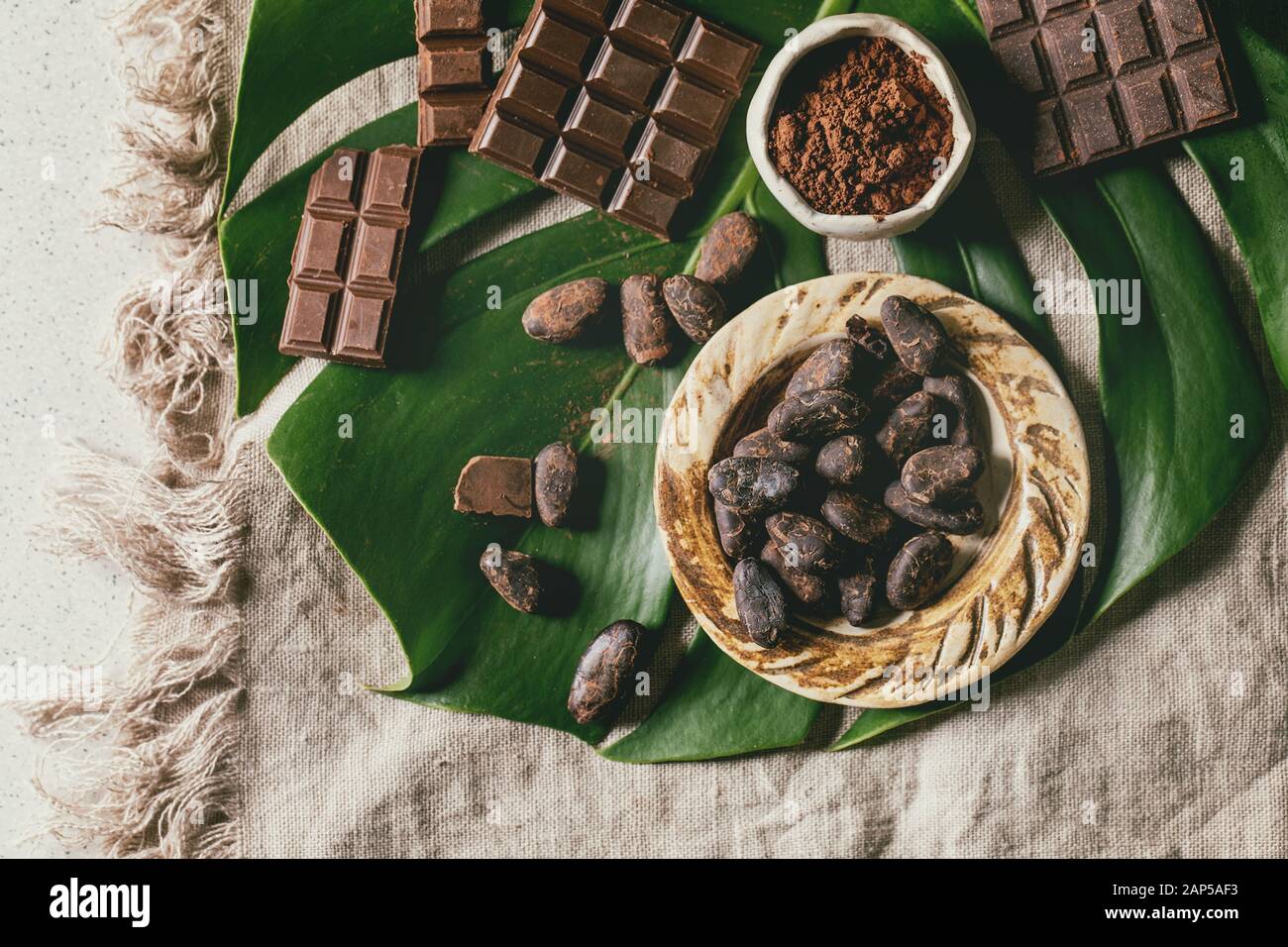 Dark and milk chocolate bar whole and chopped in ceramic plate with ...