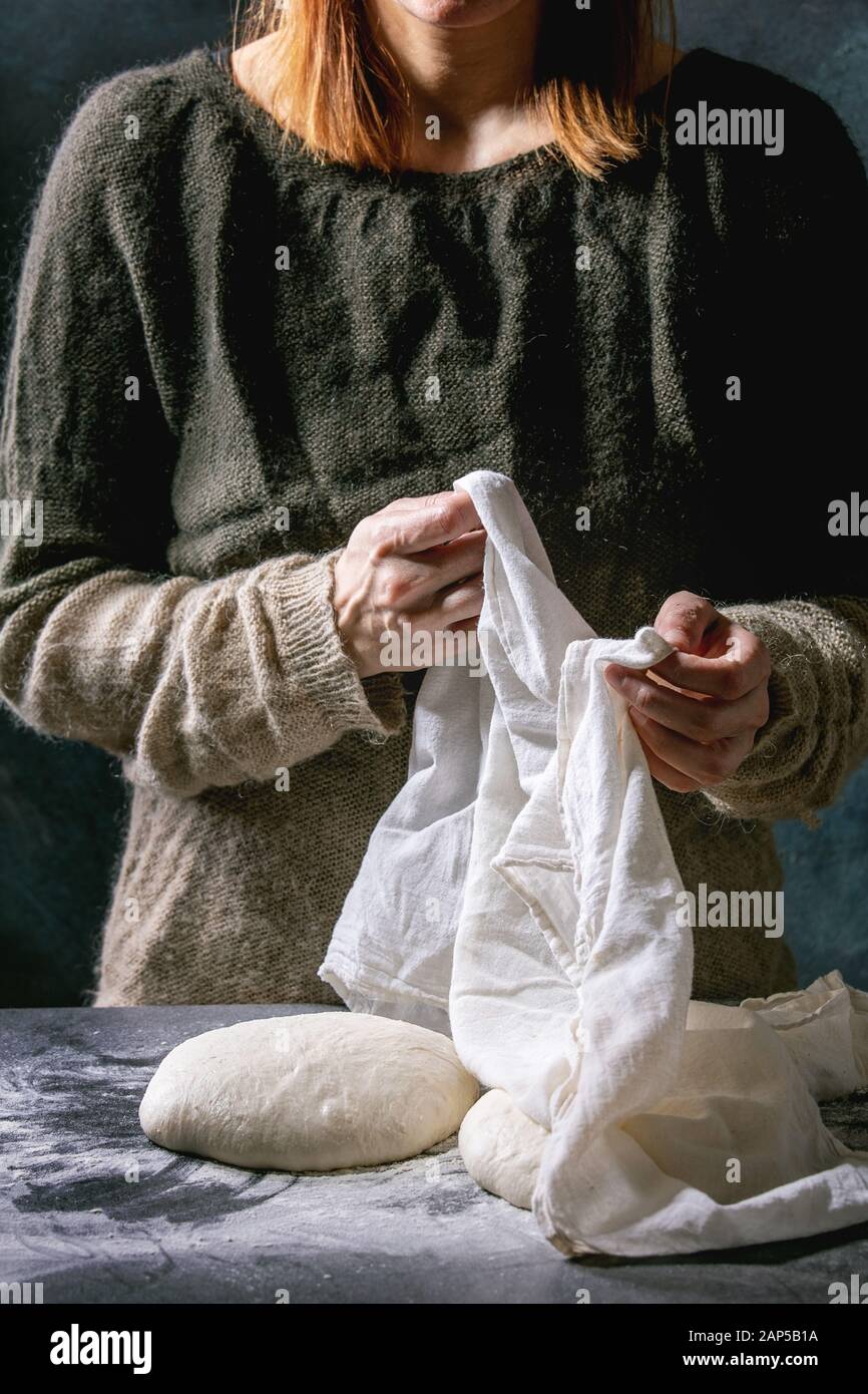 Process of making homemade bread dough. Female hands covers dough with ...