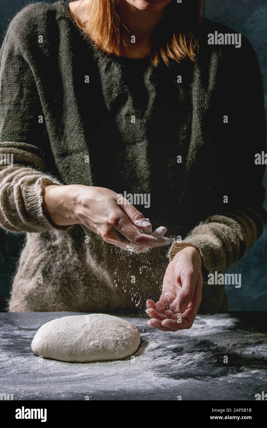 Process of making homemade bread dough. Female hands kneading dough on ...