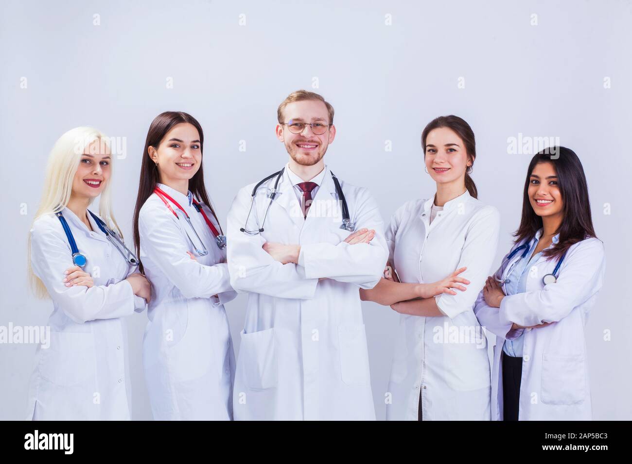 A team of young doctors in white robes. A group of medical students of ...