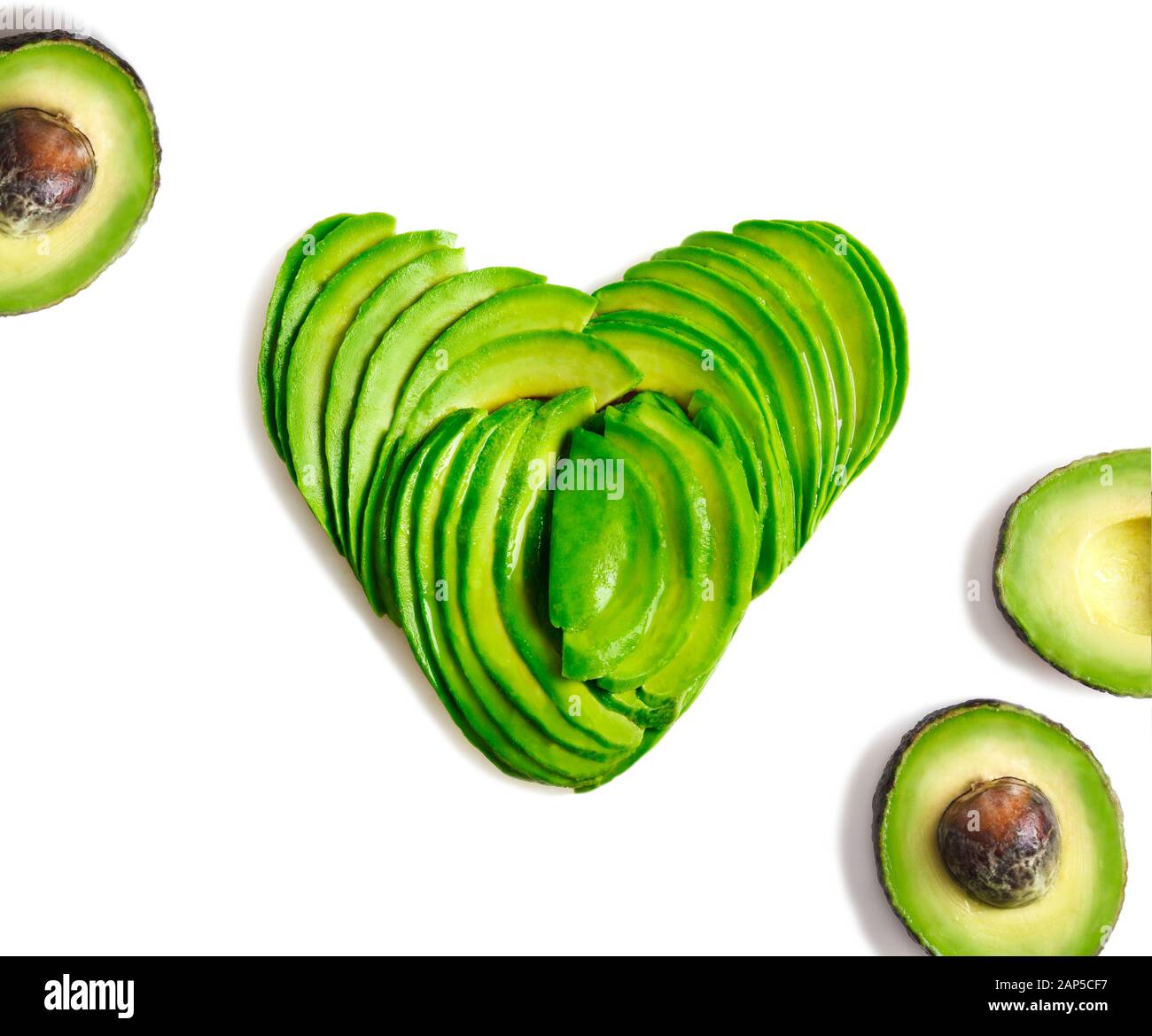 Sliced avocado in the shape of a heart isolated on white background ...