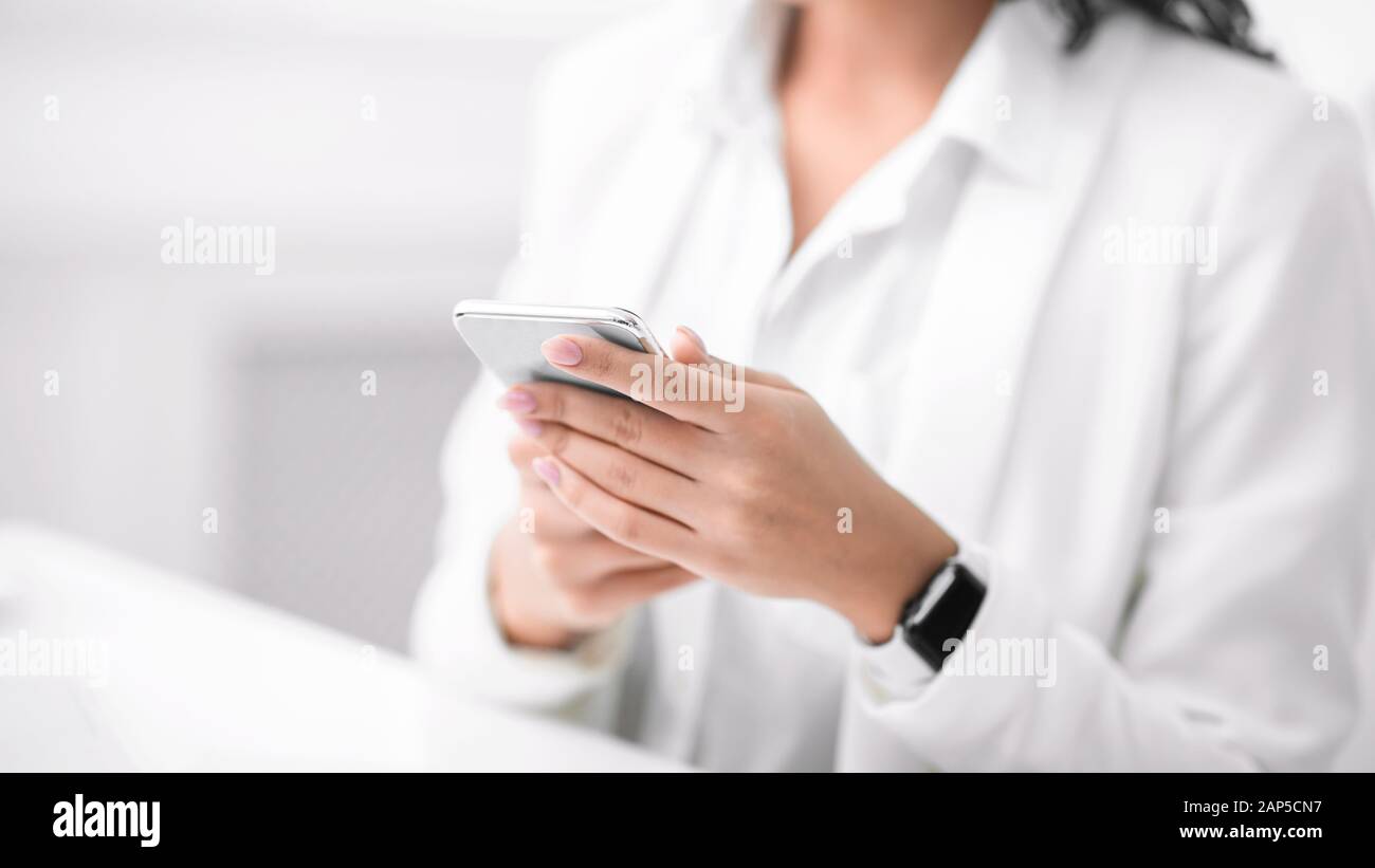 Mexican manager using mobile phone at work Stock Photo - Alamy
