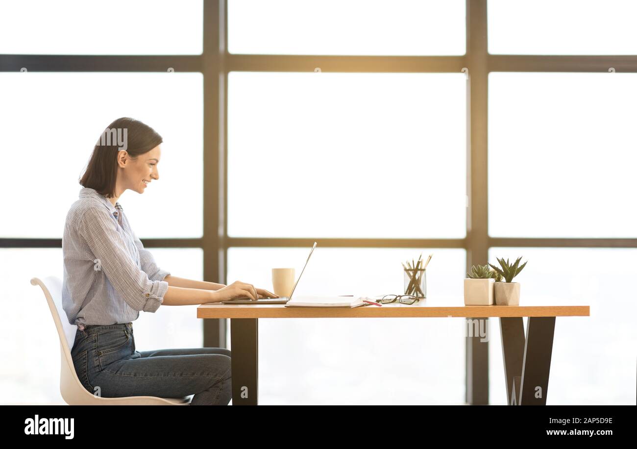 Beautiful girl working on her laptop at office Stock Photo - Alamy