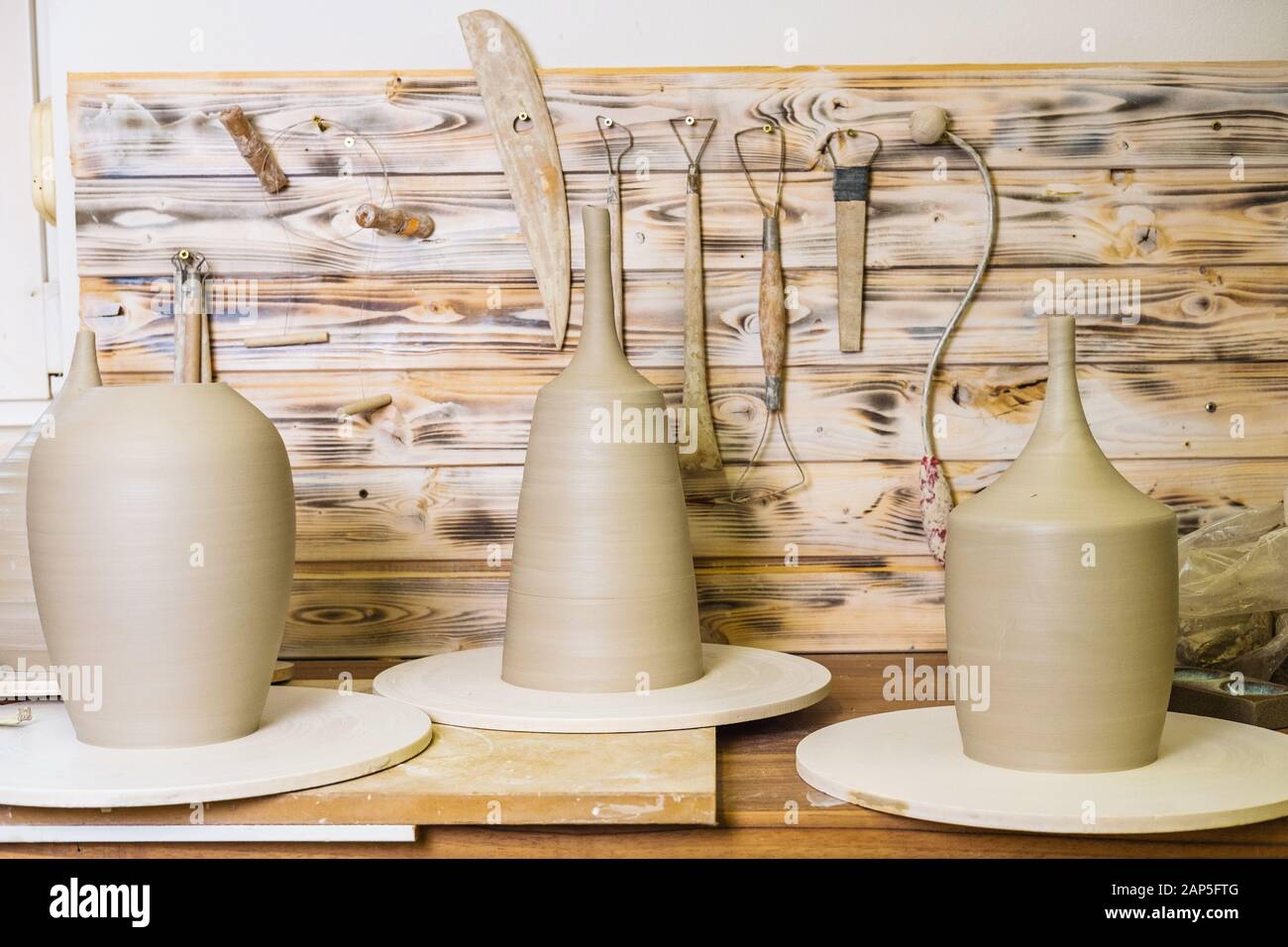 Plates and tools on pottery studio table, shallow debt of field, small ...