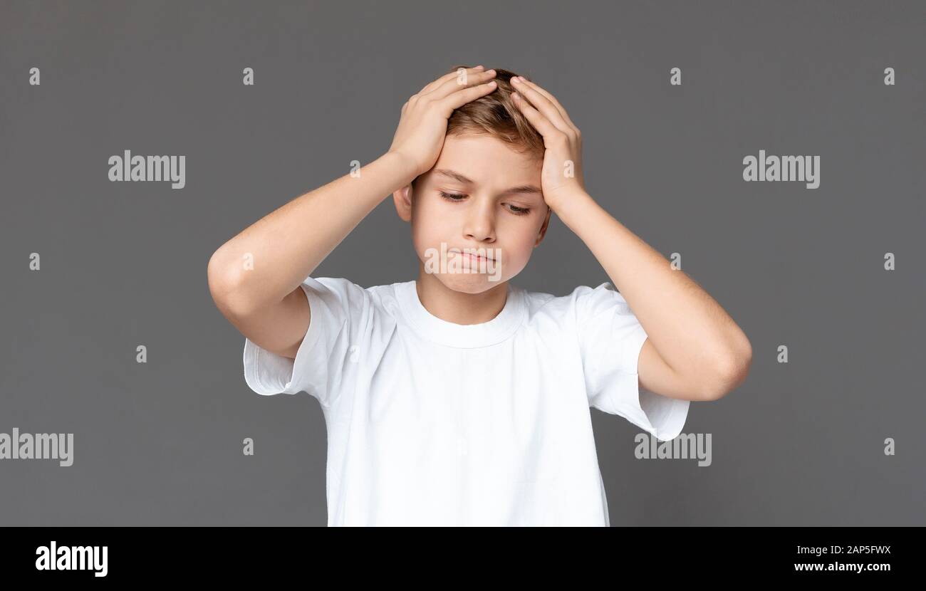 Child holding head sad hi-res stock photography and images - Alamy