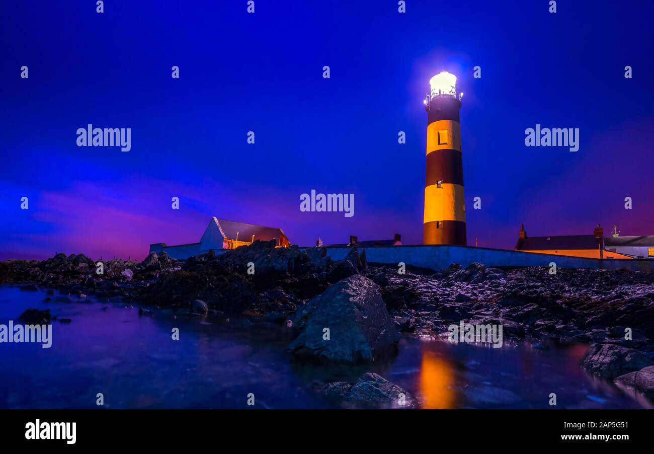 St. Johns Point Lighthouse at night with beam of light in County Down ...