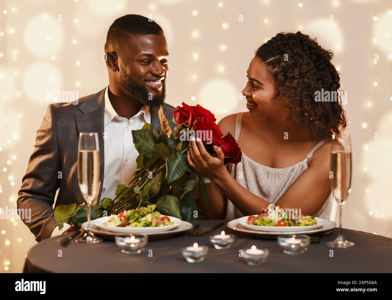 Handsome black guy giving beautiful flowers to his woman Stock Photo ...