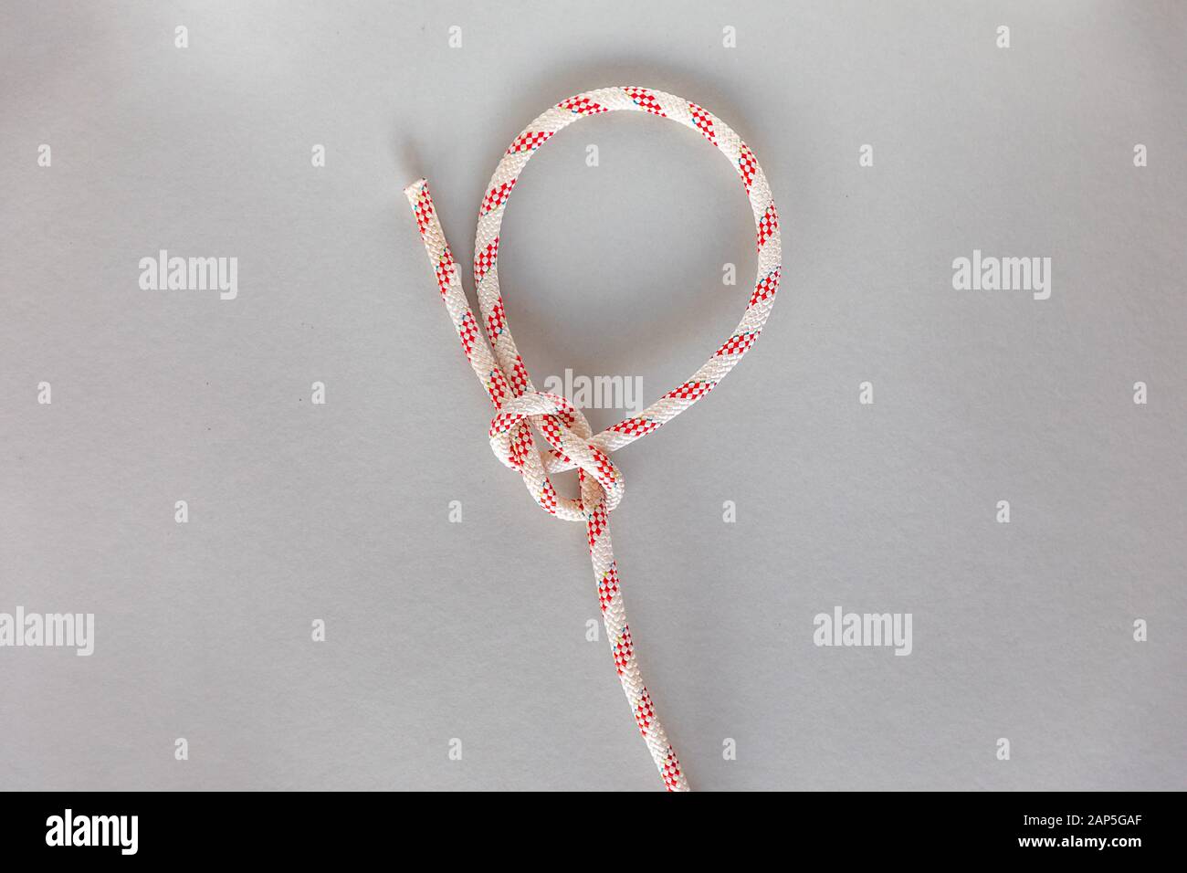 Bowline ship knot on grey background Stock Photo - Alamy