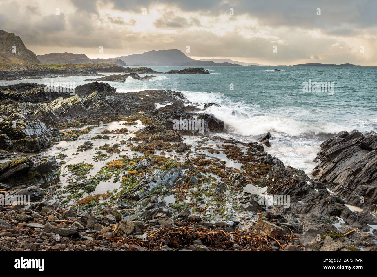 The rocky coastline of Seil with the Sound of Luing and the islands of ...
