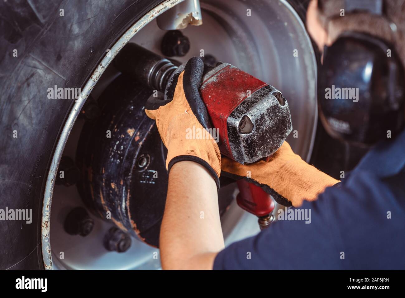 Close-up of farm machine mechanic working on wheel Stock Photo - Alamy