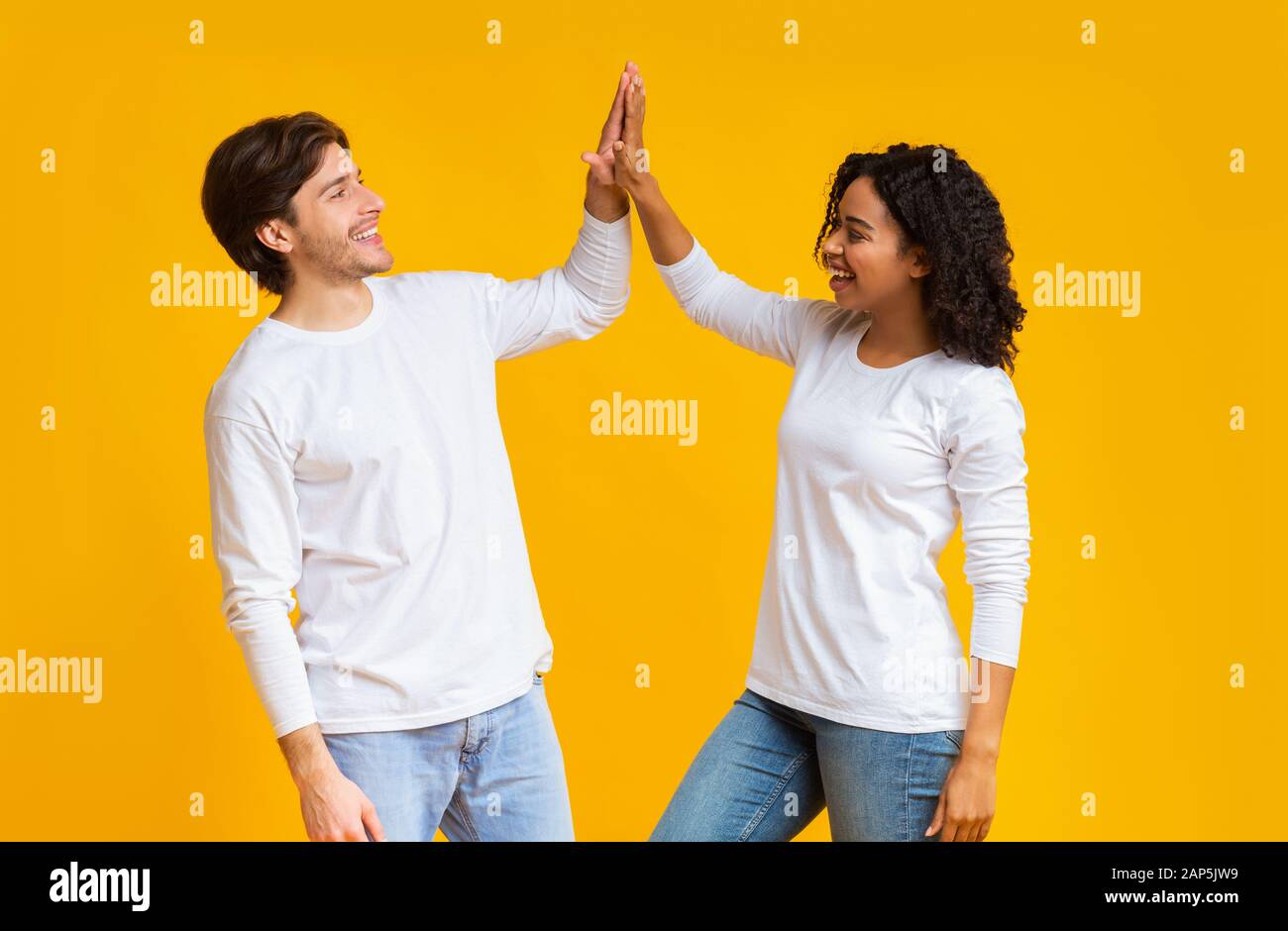 Loving Multiracial Couple Giving High Five To Each Other, Clapping ...