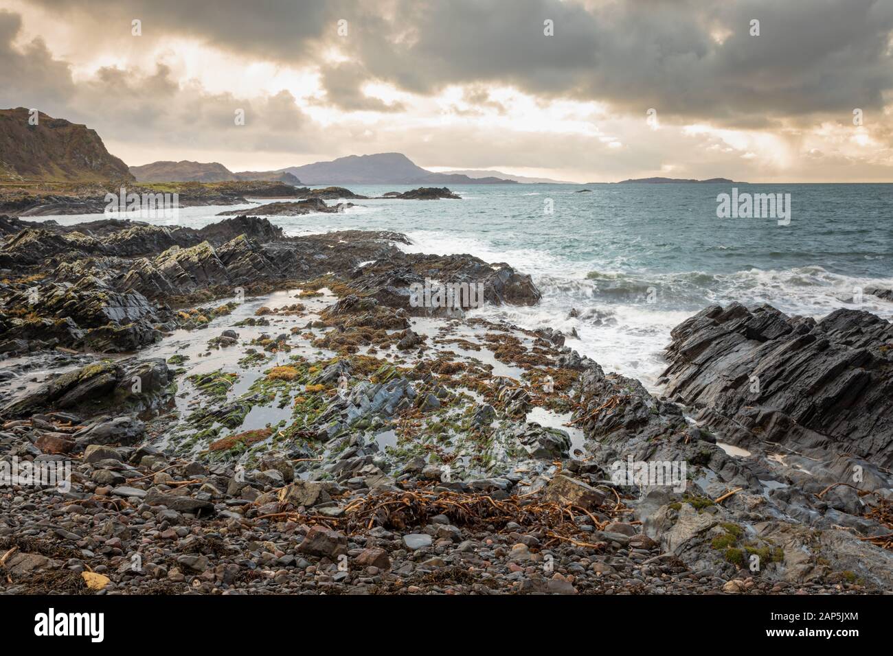 The rocky coastline of Seil with the Sound of Luing and the islands of ...