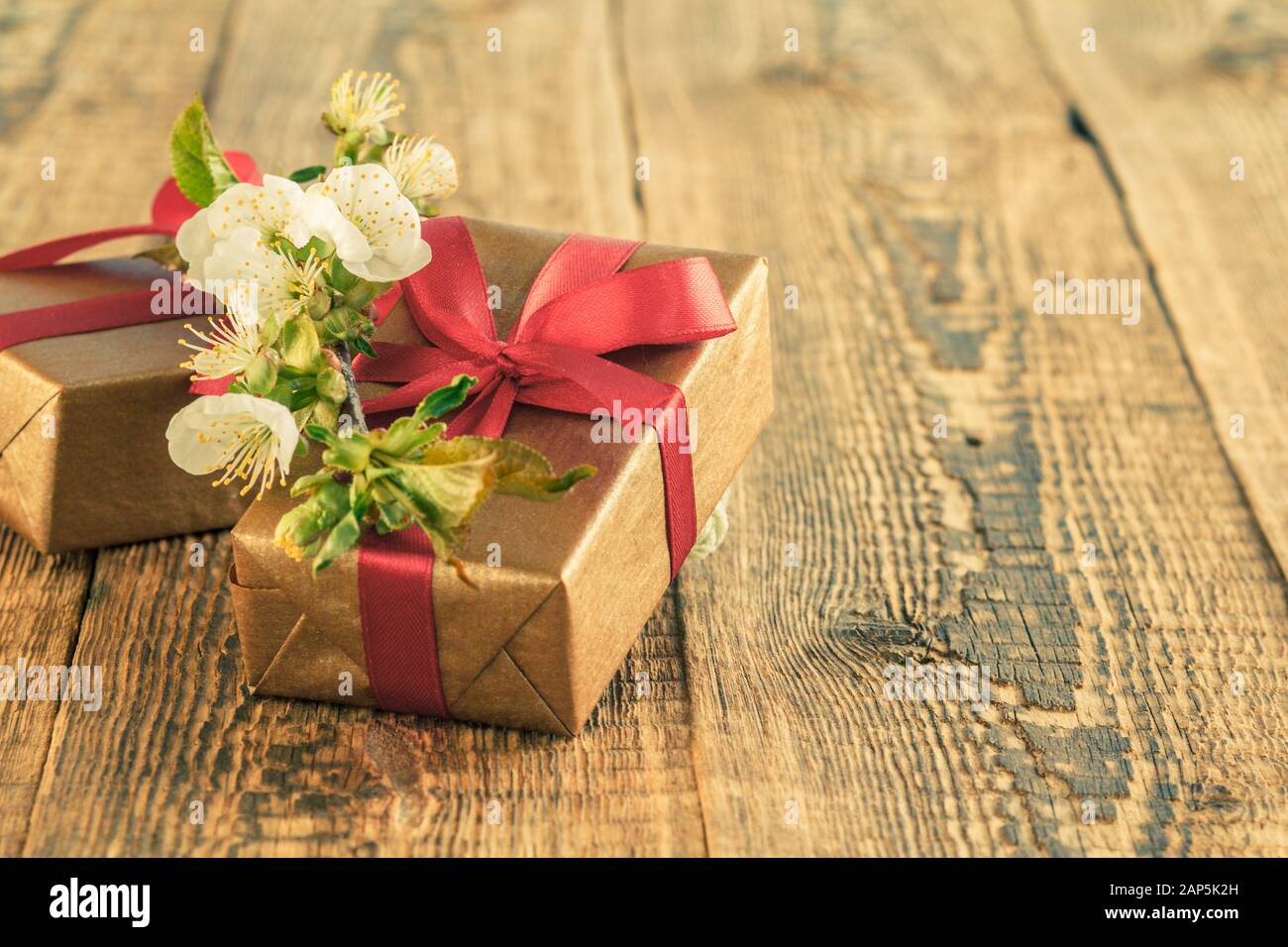 Gift boxes wrapped with red ribbons decorated with flowers of jasmine ...