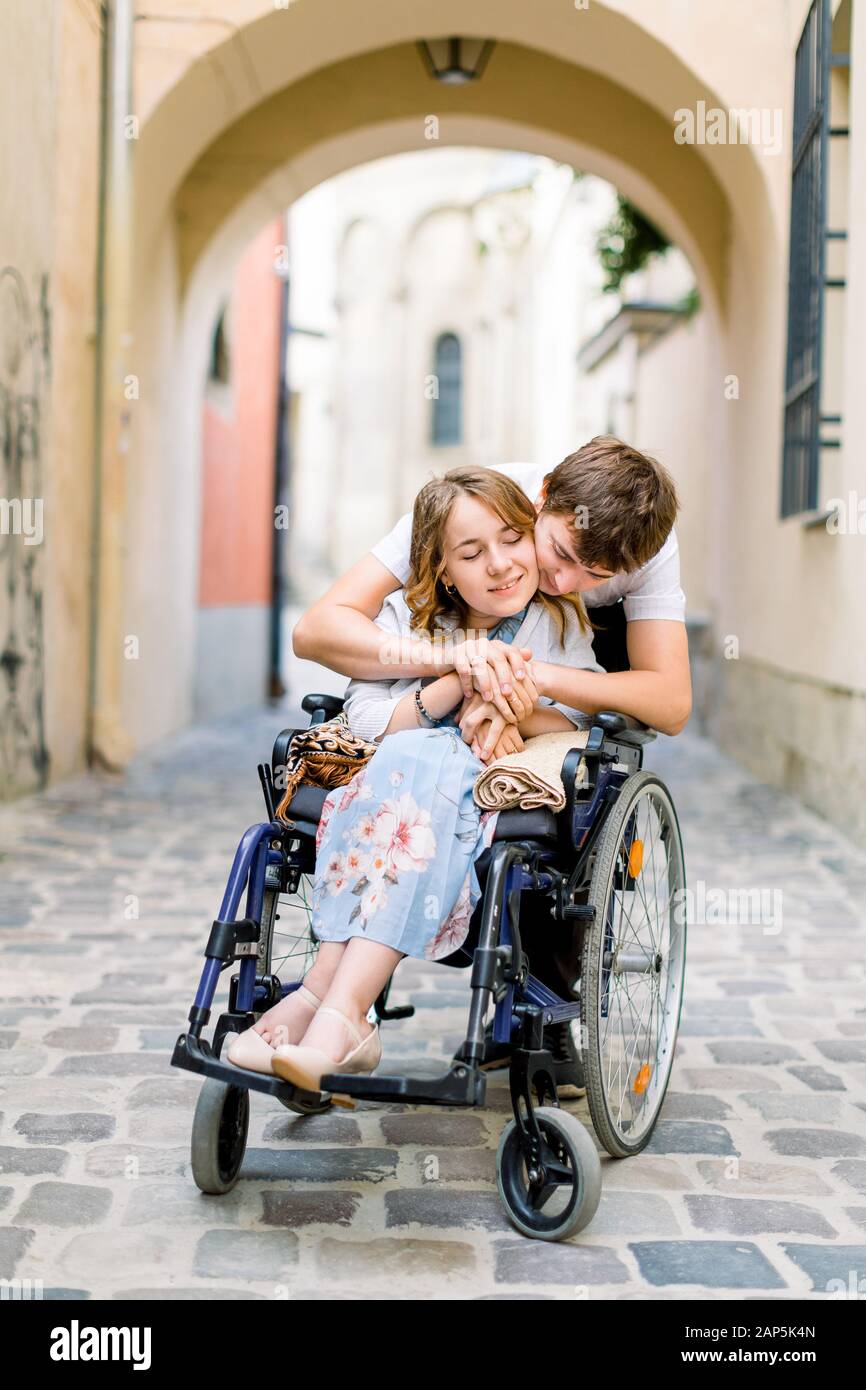 Couple in love in old city center. Pretty young girl with disease on a ...