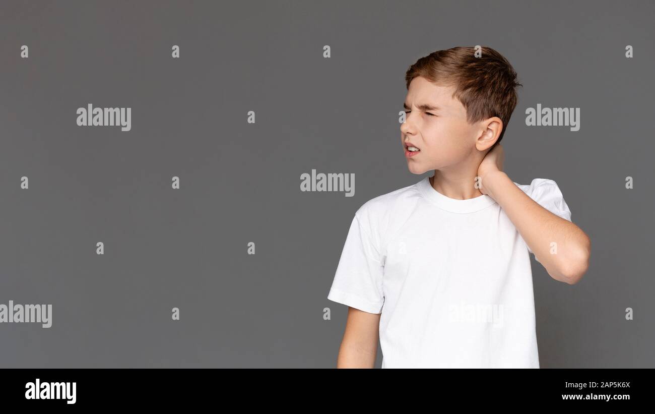 Teenage boy holding his hand behind his neck Stock Photo - Alamy