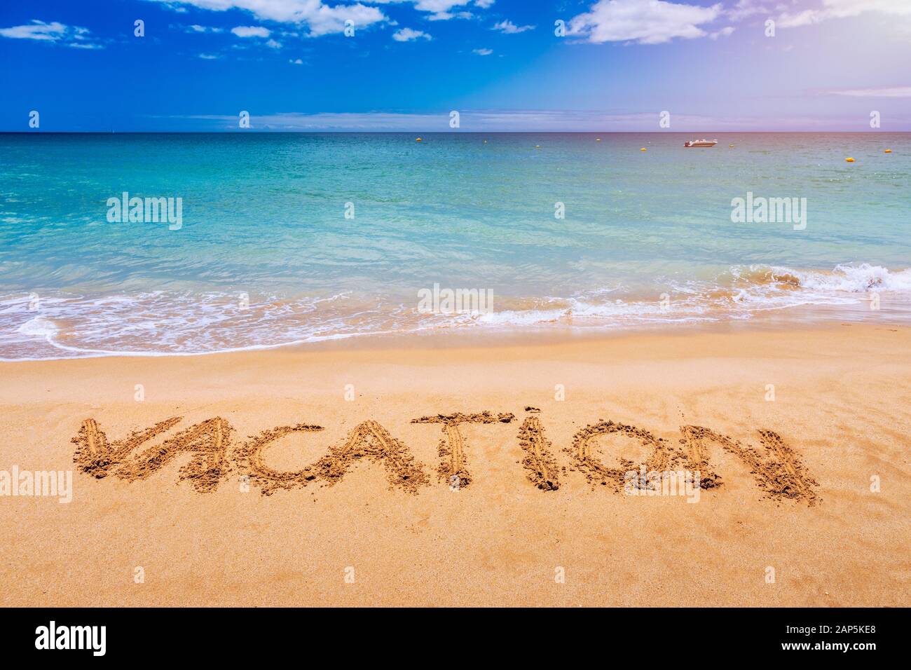 Vacation text on a beach. Vacation written in a sandy tropical beach ...