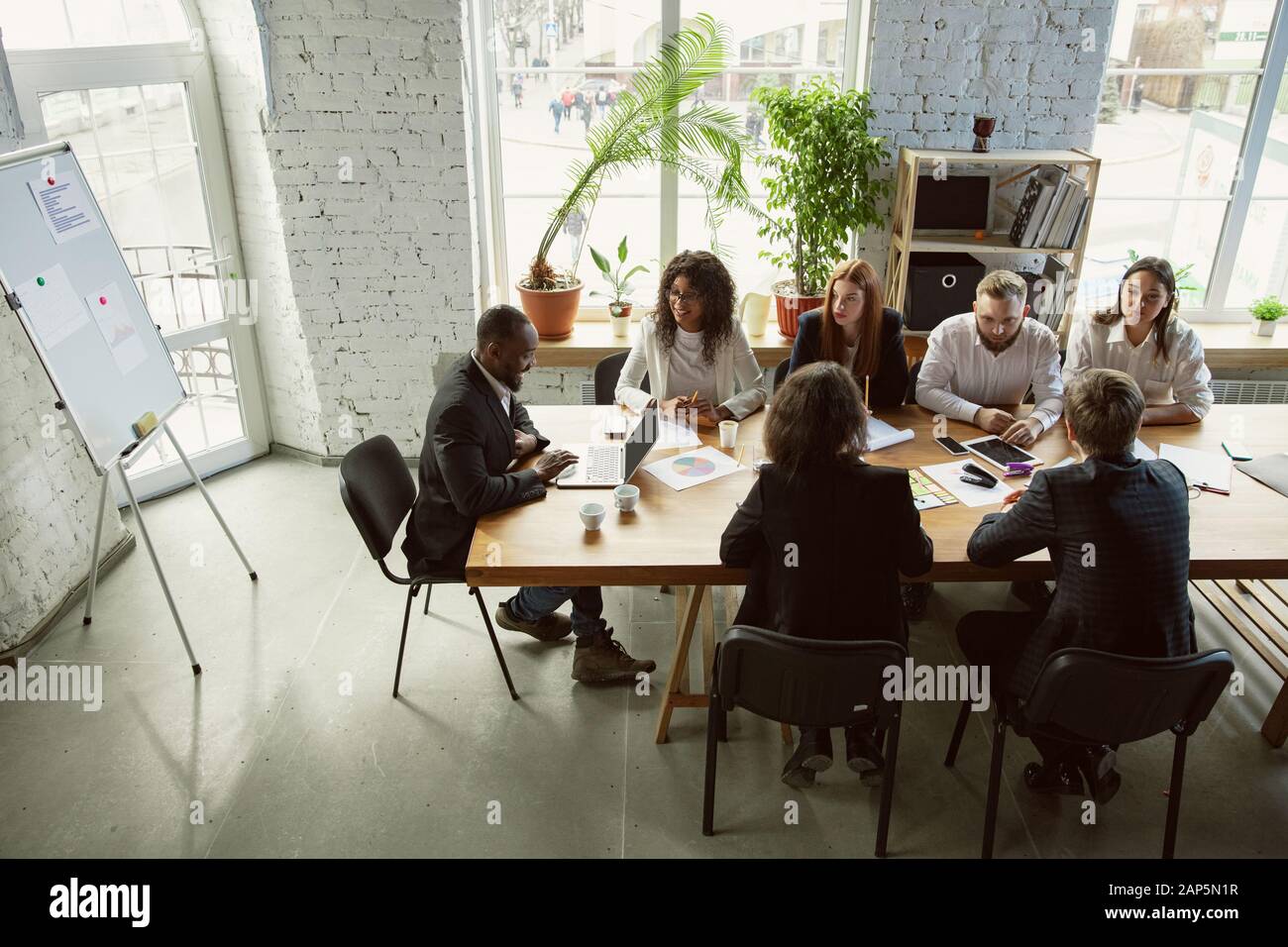 Top view. Group of young business professionals having a meeting ...