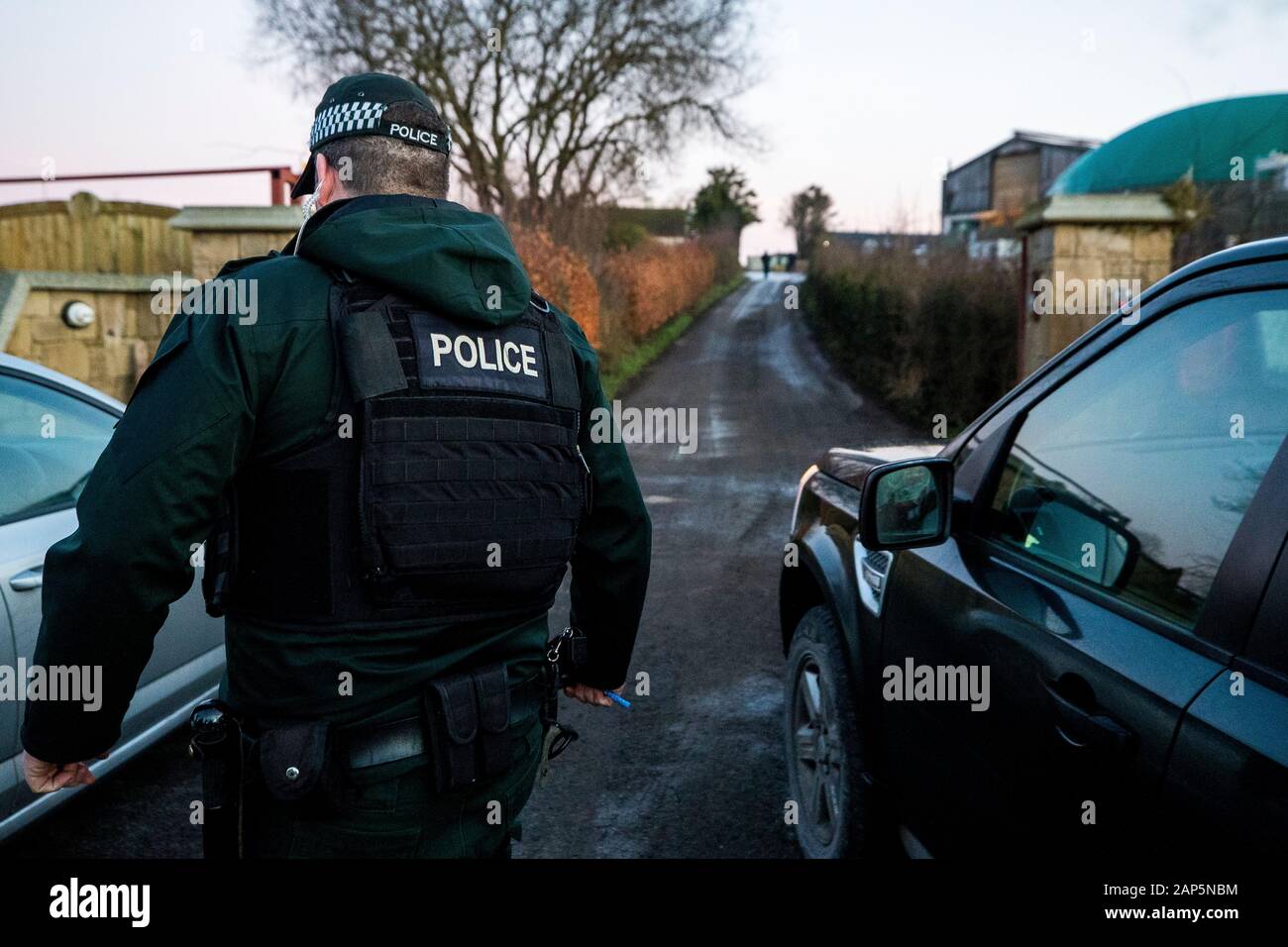 PSNI officers raiding a property as part of one of the largest money ...