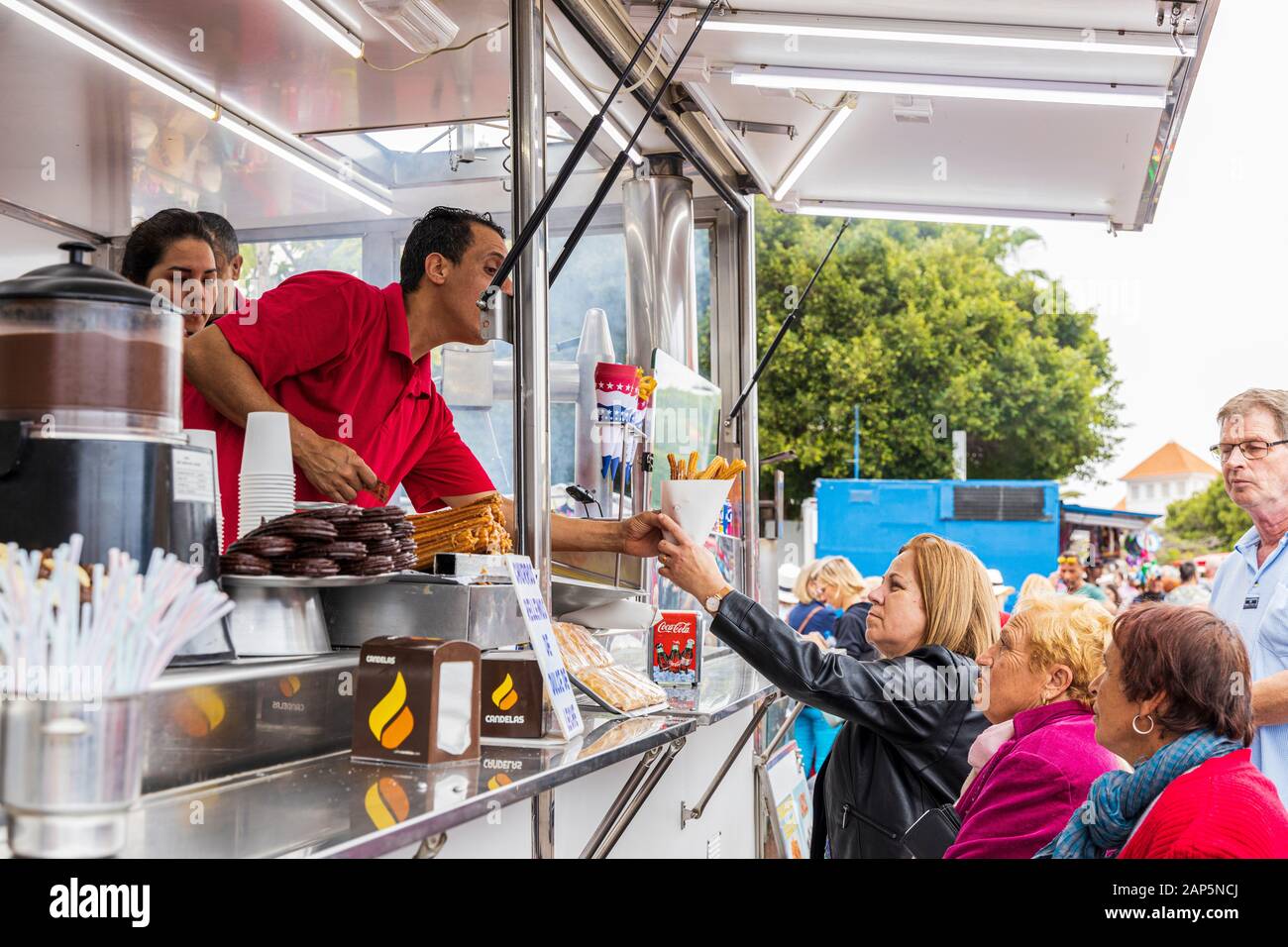 Selling churros to revellers at the San Sebastian fiesta from a fast ...