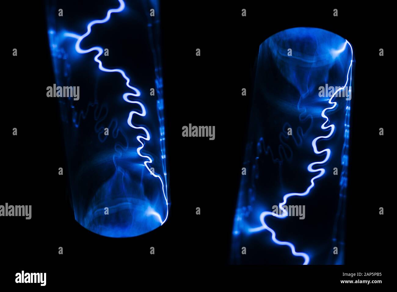 Blue electric discharge on a black background. Glowing lightning in a ...