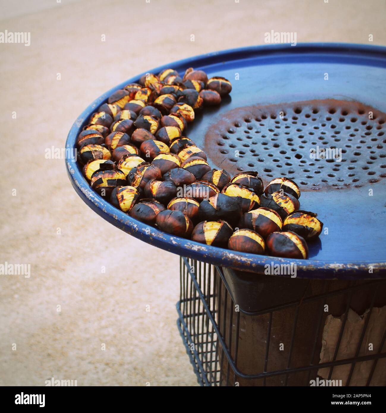 Fried chestnuts on street. Traditional street food in winter fire ...