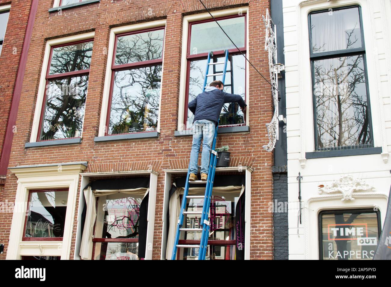 Groningen, Netherlands - Januari 16, 2020: Male window cleaner on a ...