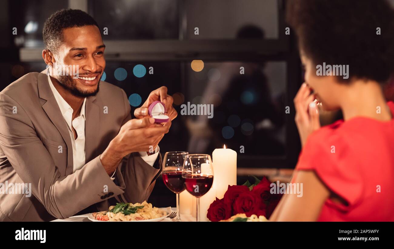 Guy Proposing Giving Girlfriend Engagement Ring During Date In ...