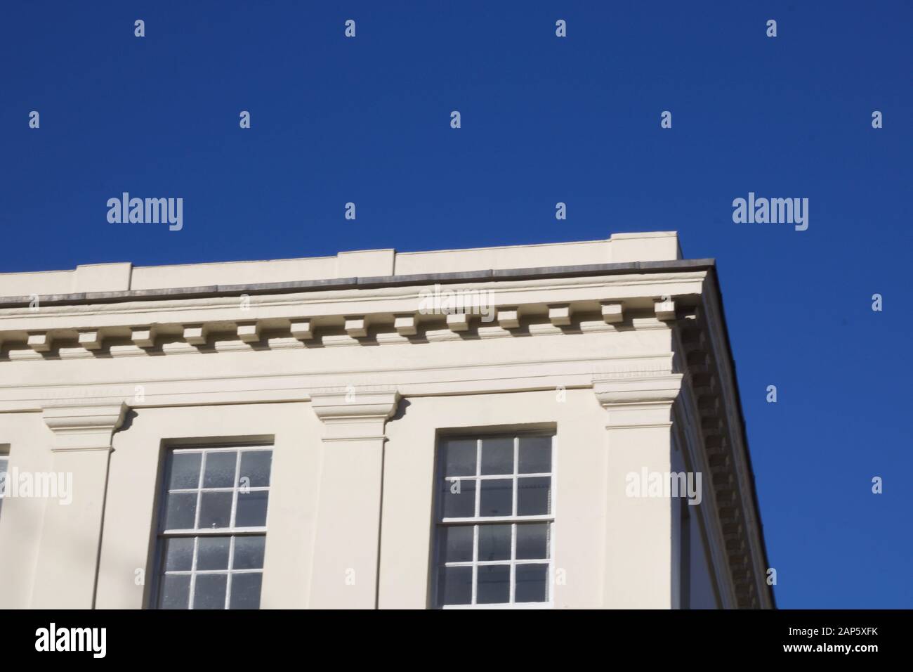 Traditional white building against deep blue sky Stock Photo - Alamy