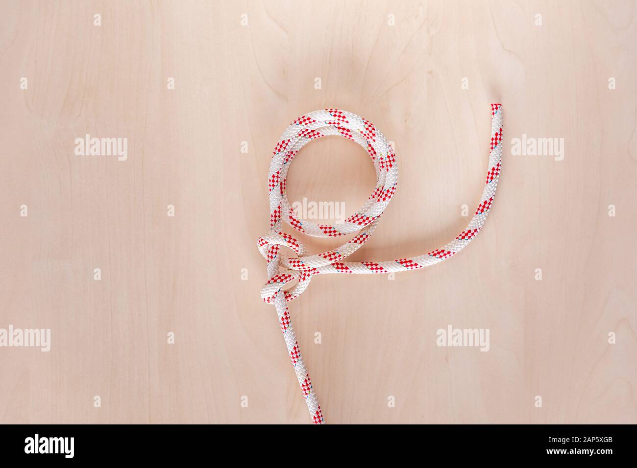 Round turn and two half hitches ship knot on wooden background Stock ...