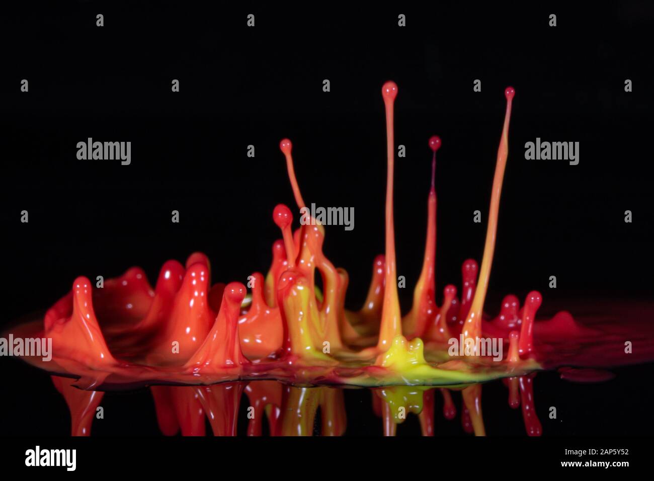 Color ink splash on a black background Stock Photo - Alamy