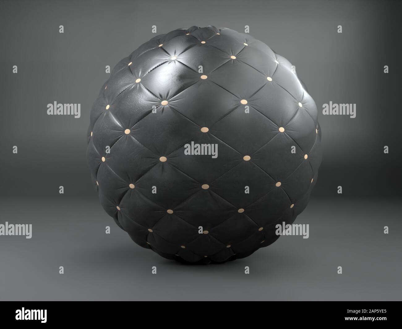 Black leather sphere bradded with golden hobnails on gray background ...