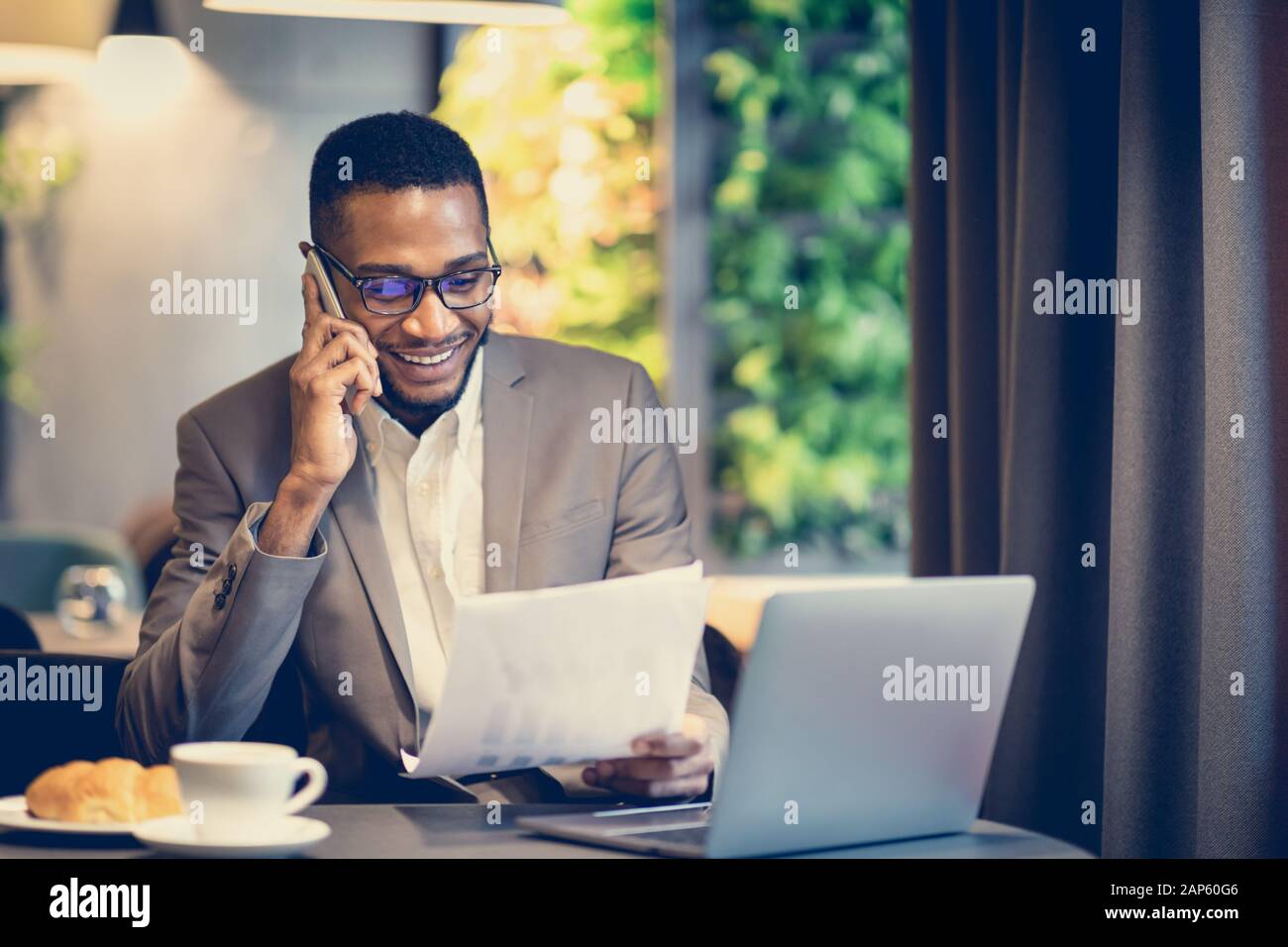 Portrait of afro businessman making phone call Stock Photo - Alamy
