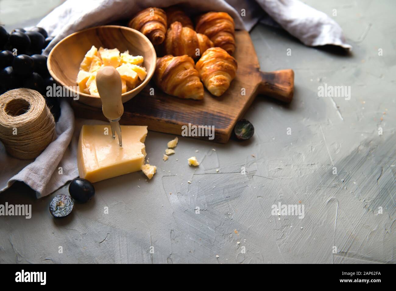 Original tasty French croissants with cheese and grapes on the wooden ...