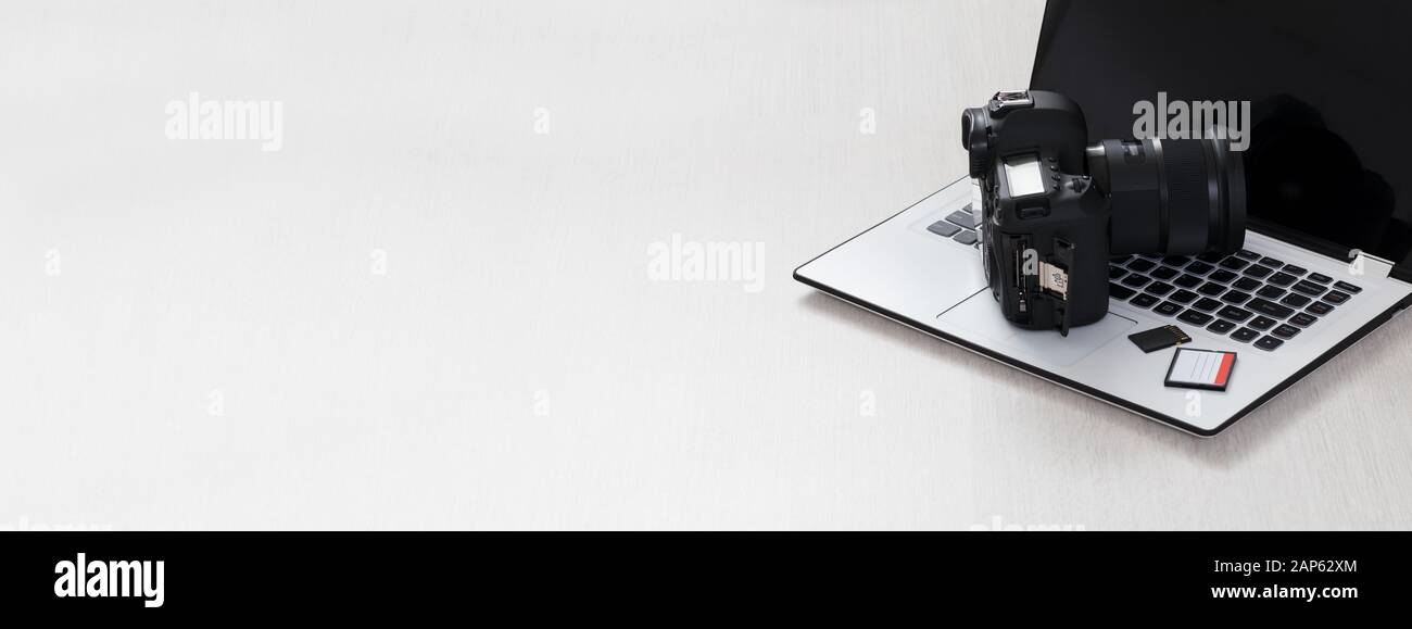 Modern digital DSLR camera and computer workstation. Photography and ...