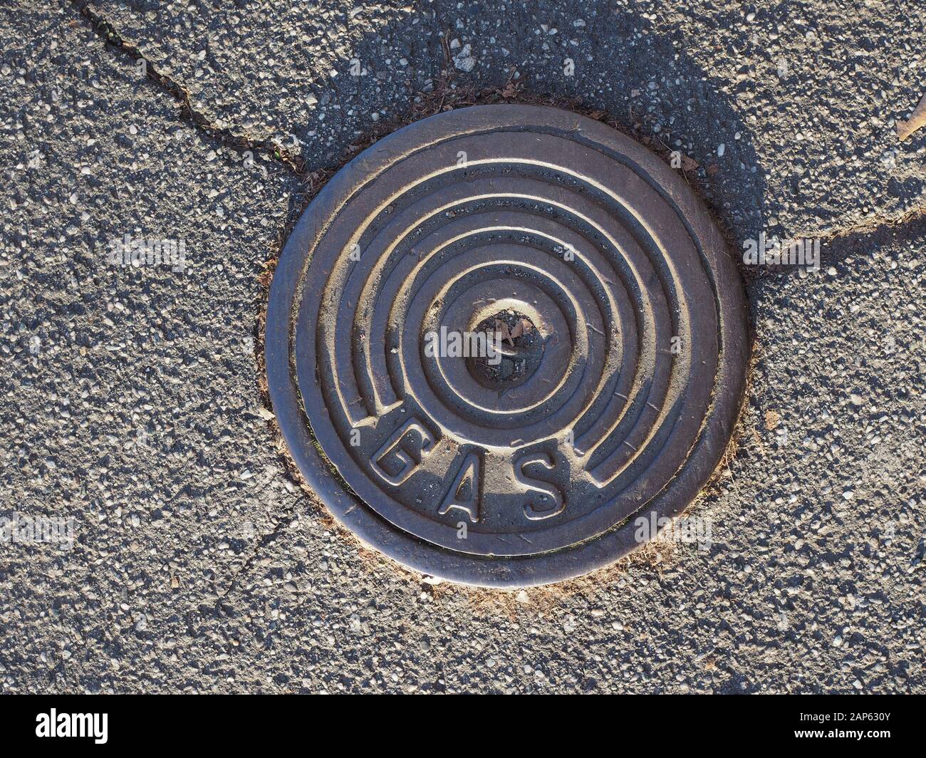 steel gas manhole in the street with tarmac Stock Photo - Alamy